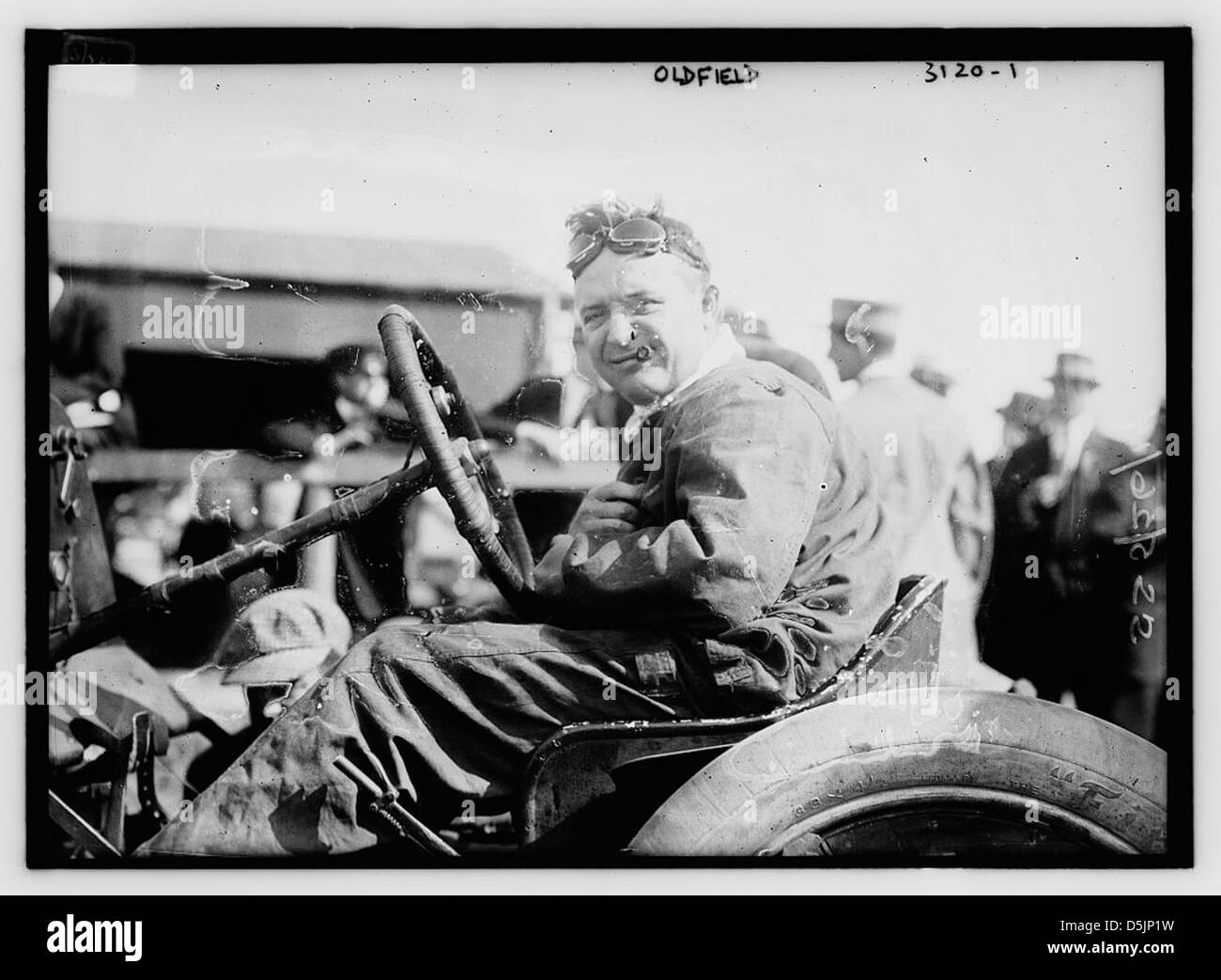 Barney Oldfield, a pioneering auto racing driver, is shown with his ...