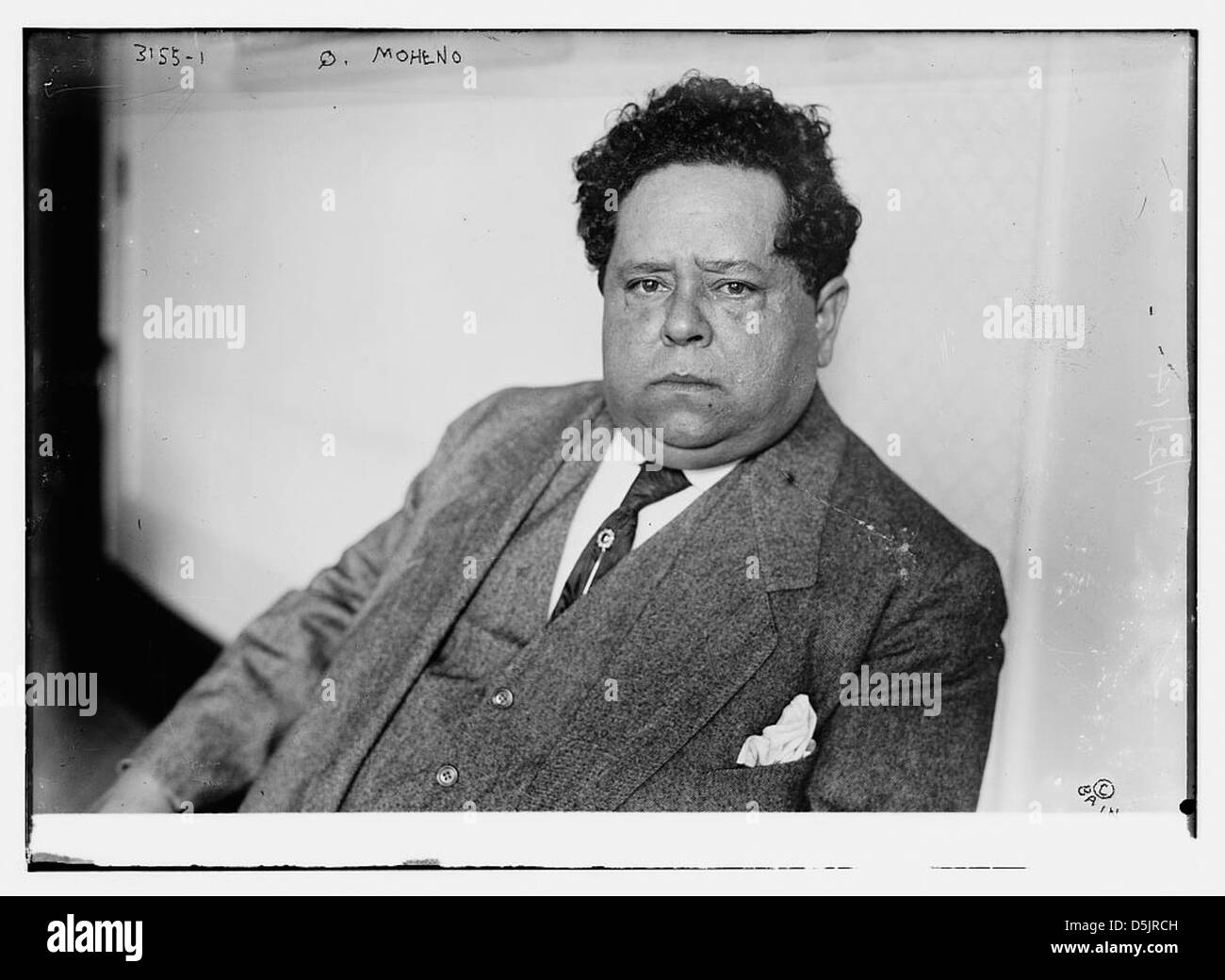 A portrait of a man named Q. Moheno, captured in a formal photograph ...