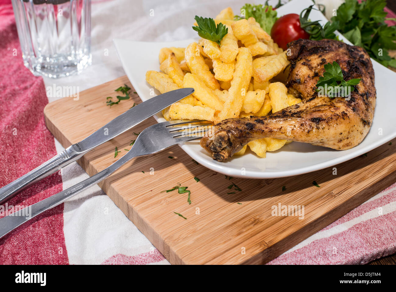Grilled Chicken legs with Chips on a plate Stock Photo - Alamy