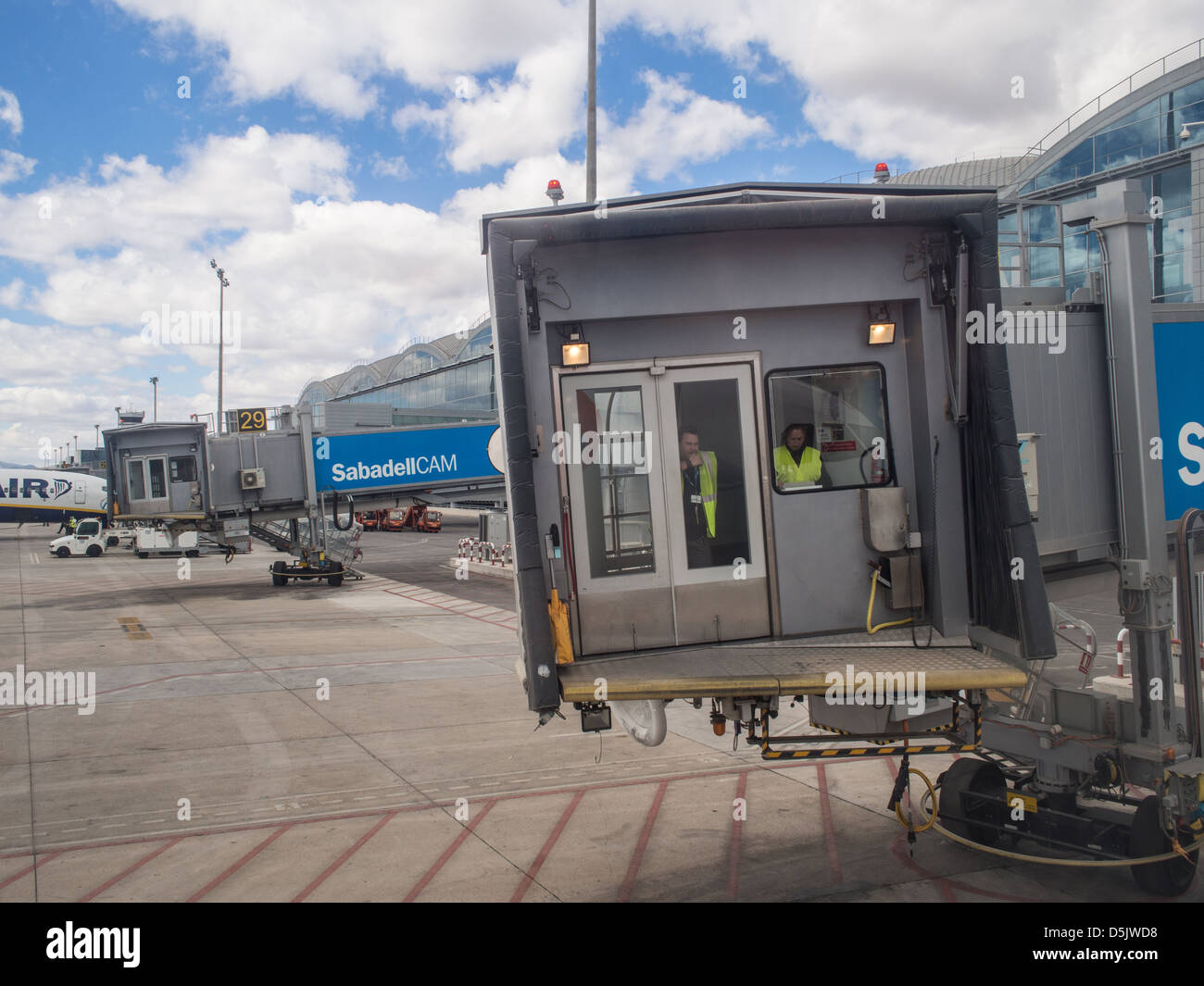 A passenger walkway is readied to dock with a recently landed plane at ...