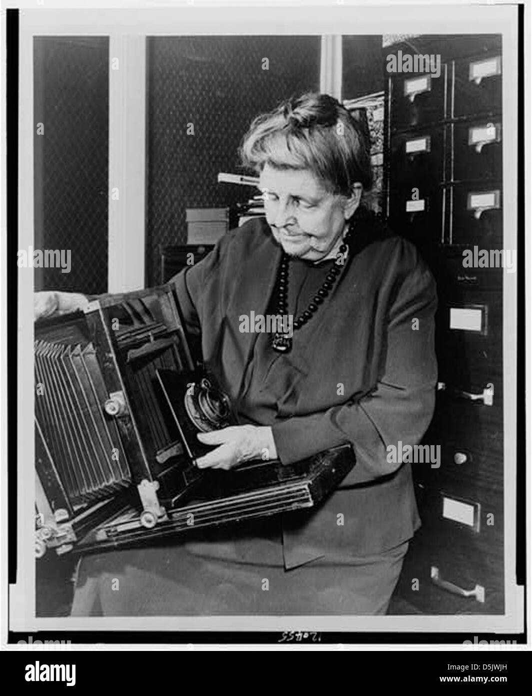 This three-quarter length portrait captures Frances Benjamin Johnston ...