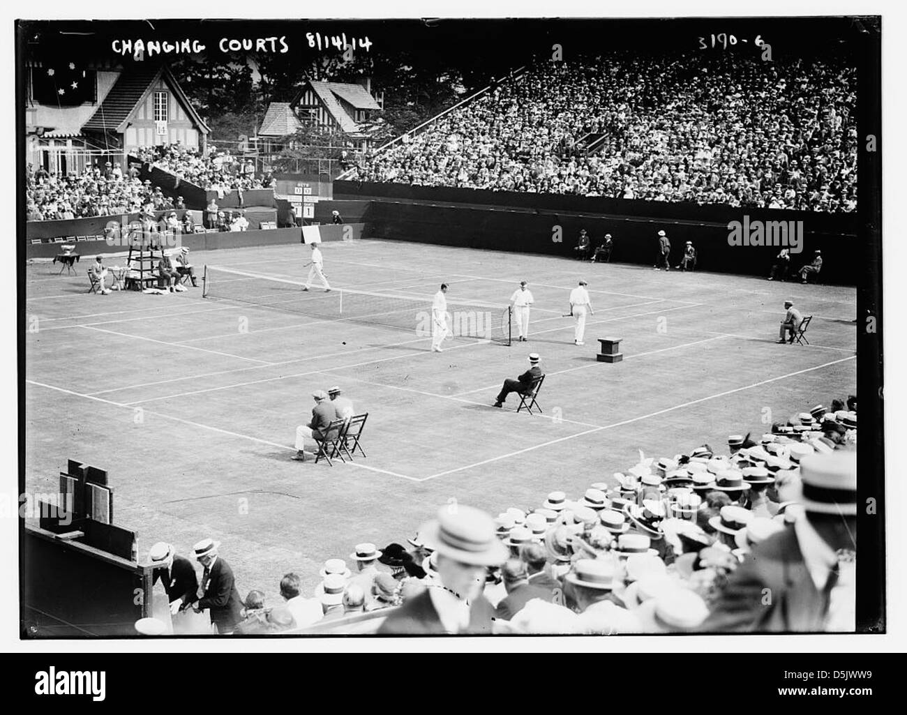 A photograph from 1914 showing a crowd of spectators at a tennis match ...