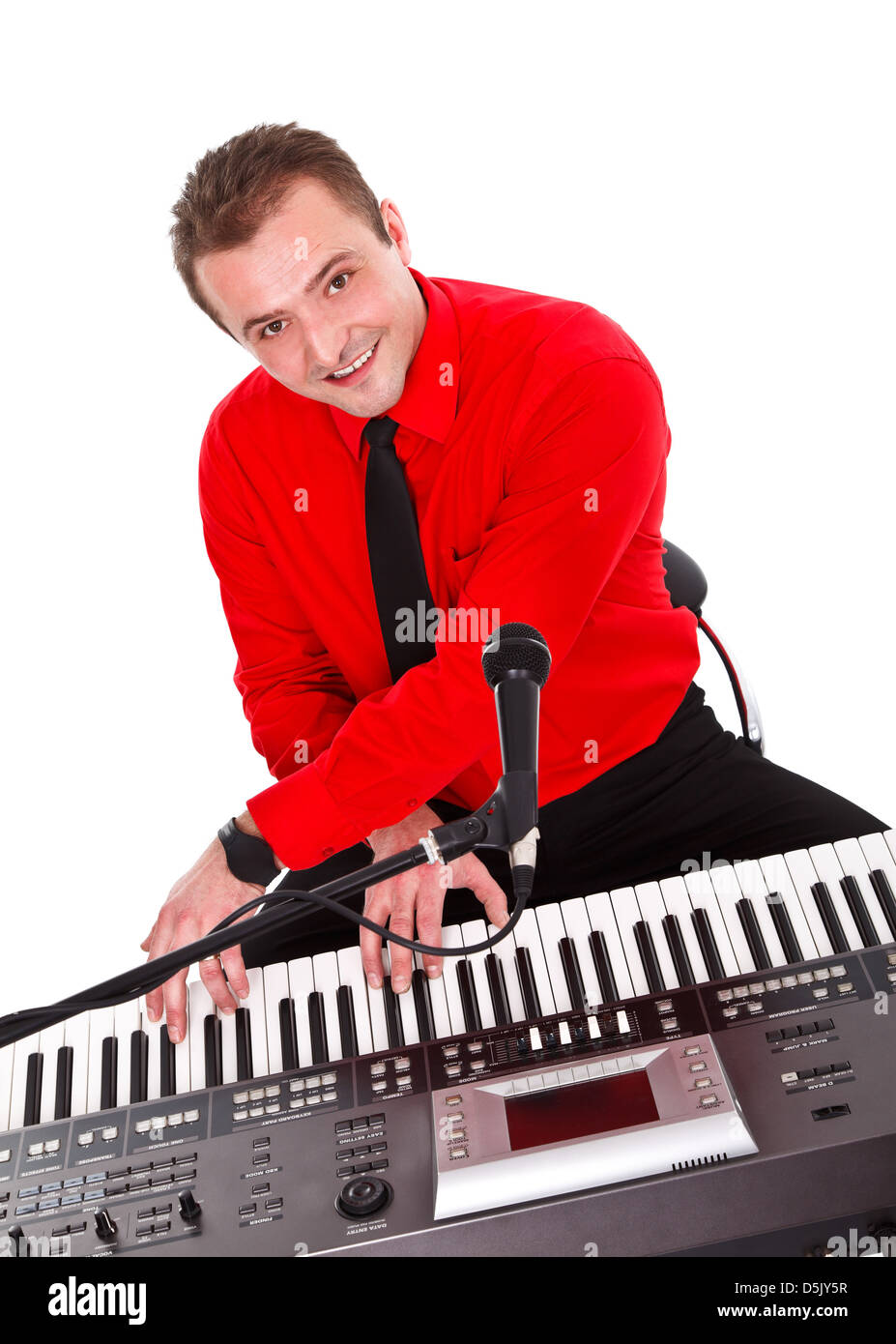 Smiling singer playing electric synthesizer over white background Stock ...