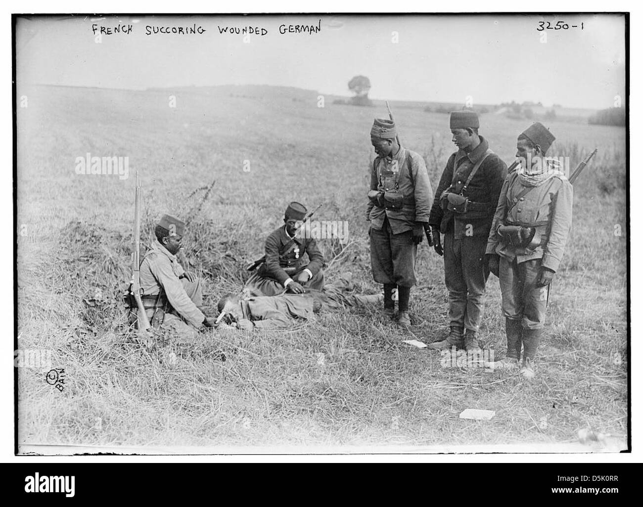 A French soldier is seen providing first aid to a wounded German ...