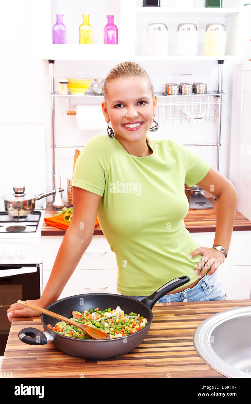 Lovely girl posing in the kitchen with healthy food made of fresh mixt ...