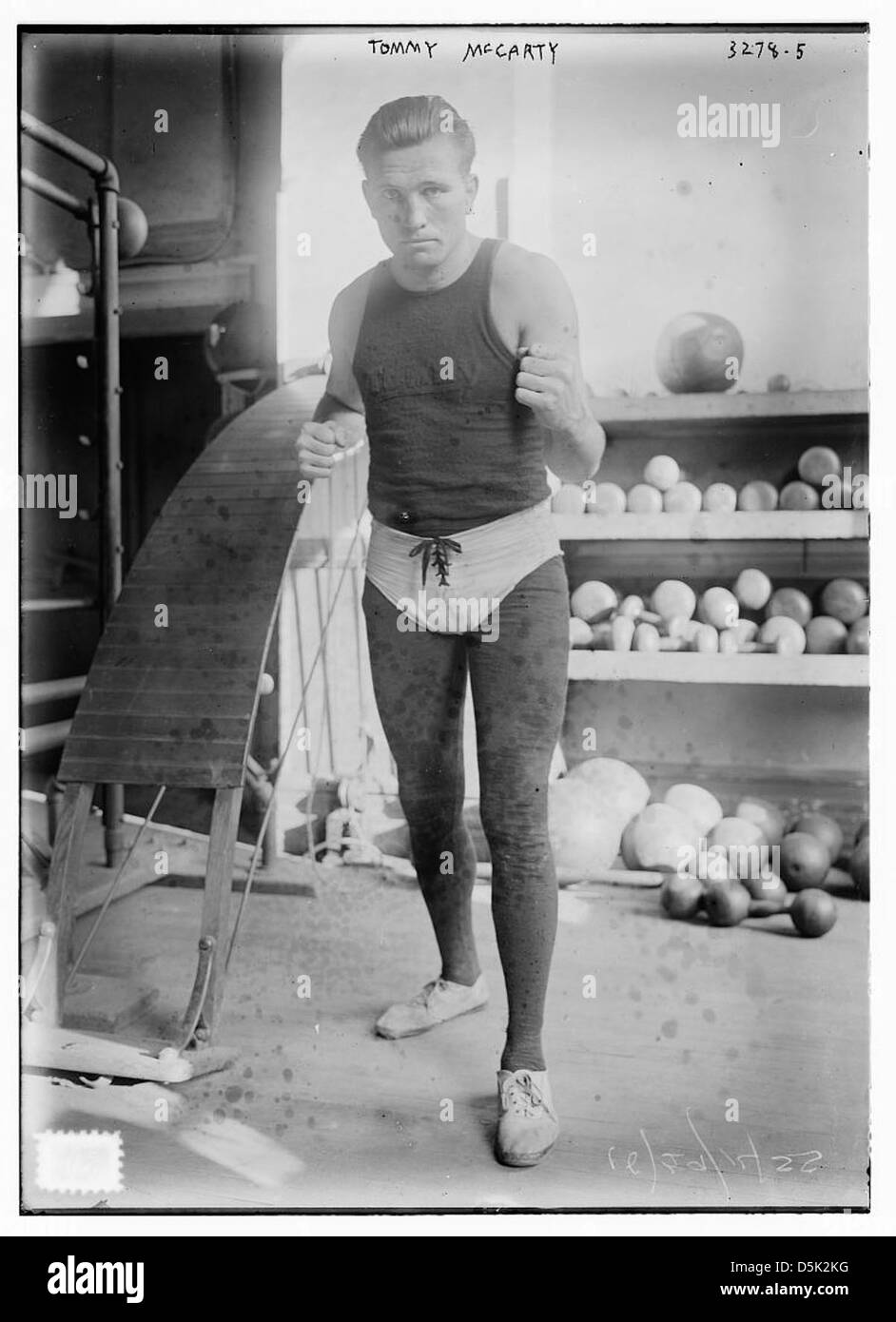 This photograph features Tommy McCarty, a renowned boxer, captured in ...