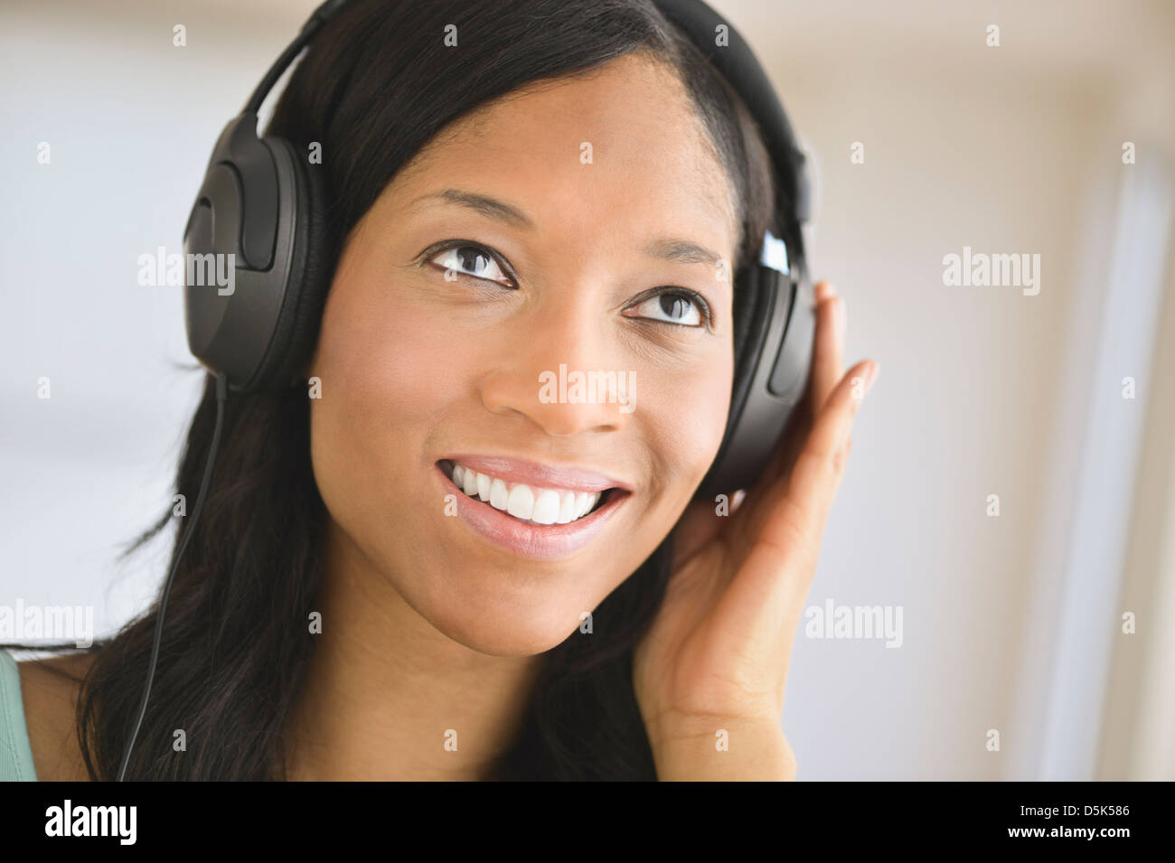 Happy african female listening music hi-res stock photography and images - Alamy