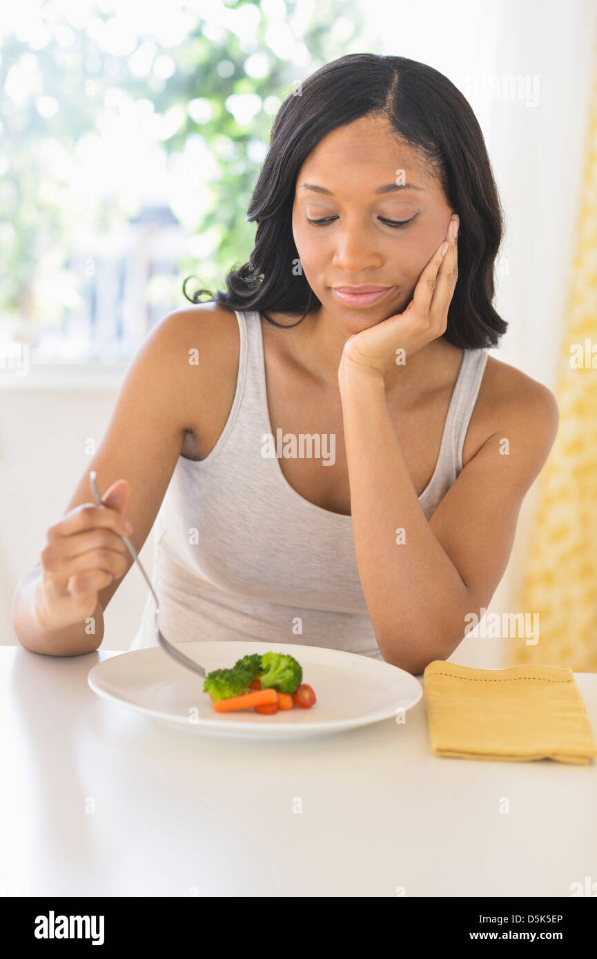 Woman eating vegetables Stock Photo - Alamy