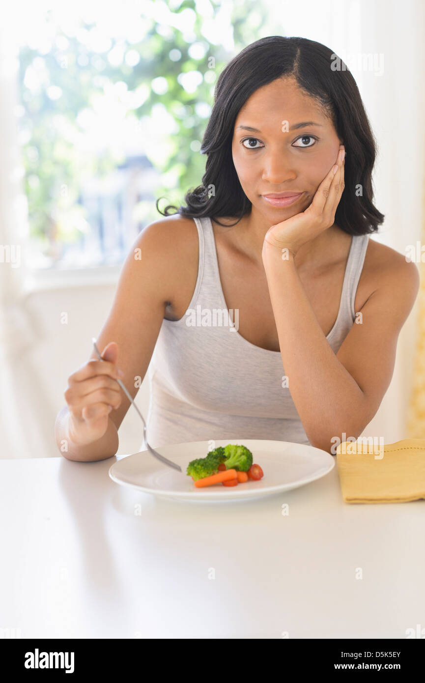 Woman eating vegetables Stock Photo - Alamy