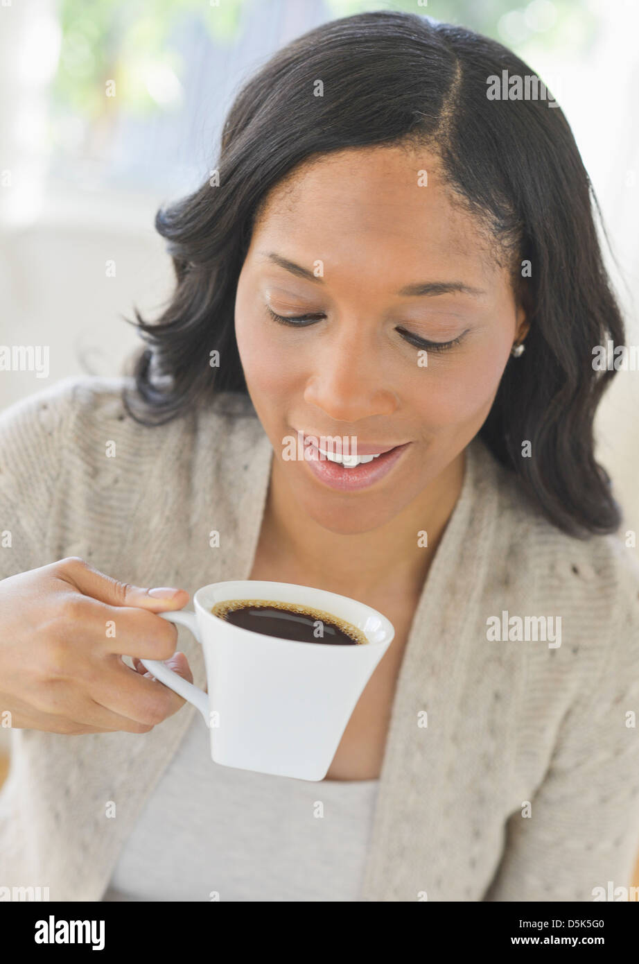 Smiling woman smelling coffee hi-res stock photography and images - Alamy