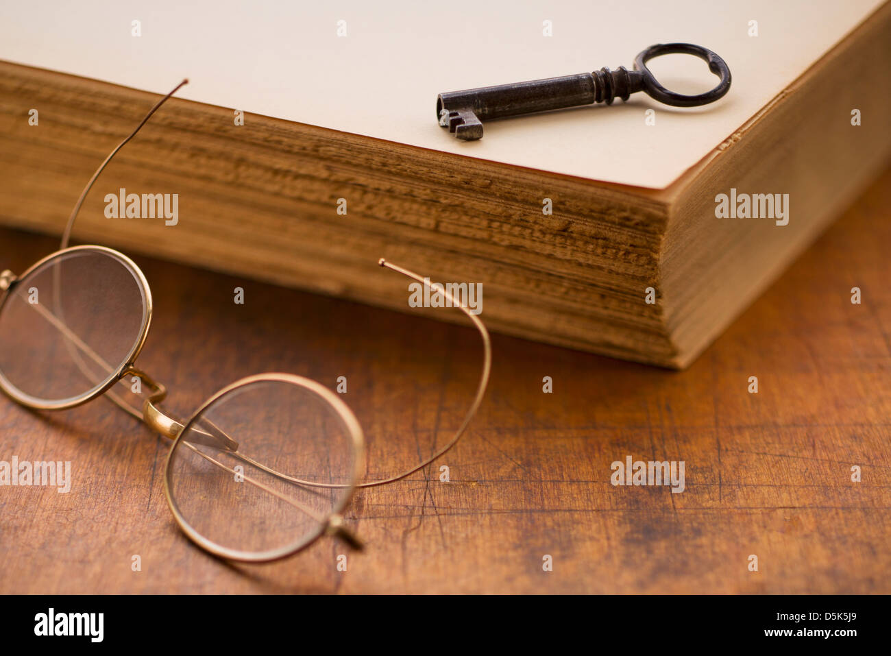 Antique book with key and eyeglasses Stock Photo - Alamy
