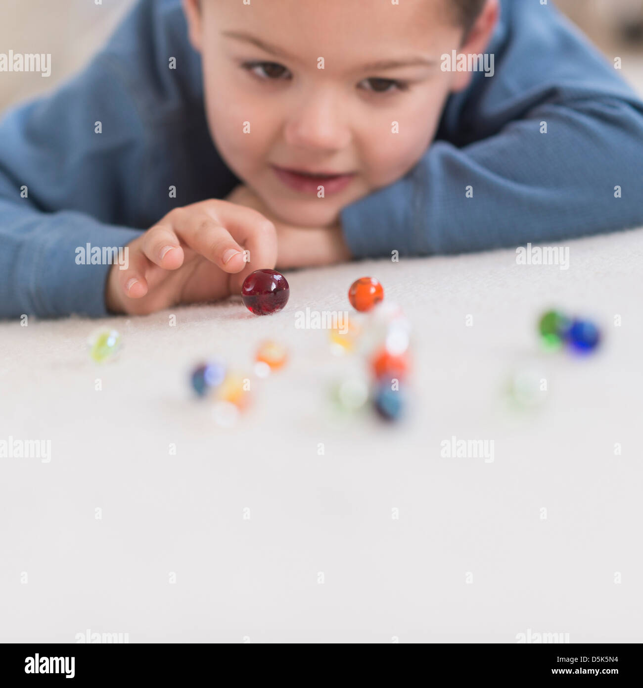 Boy playing marbles hi-res stock photography and images - Alamy