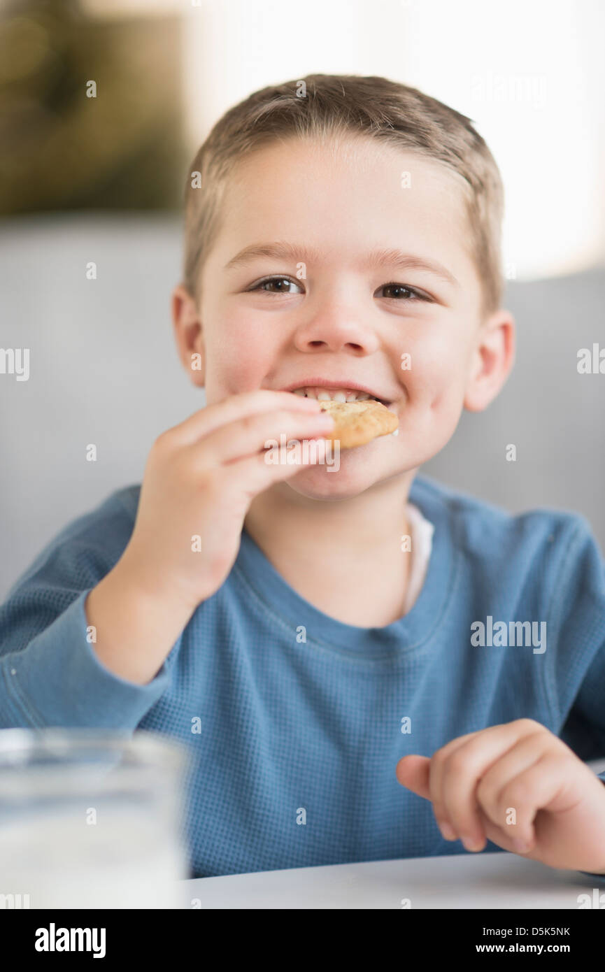 Boy (4-5) eating cookie Stock Photo - Alamy