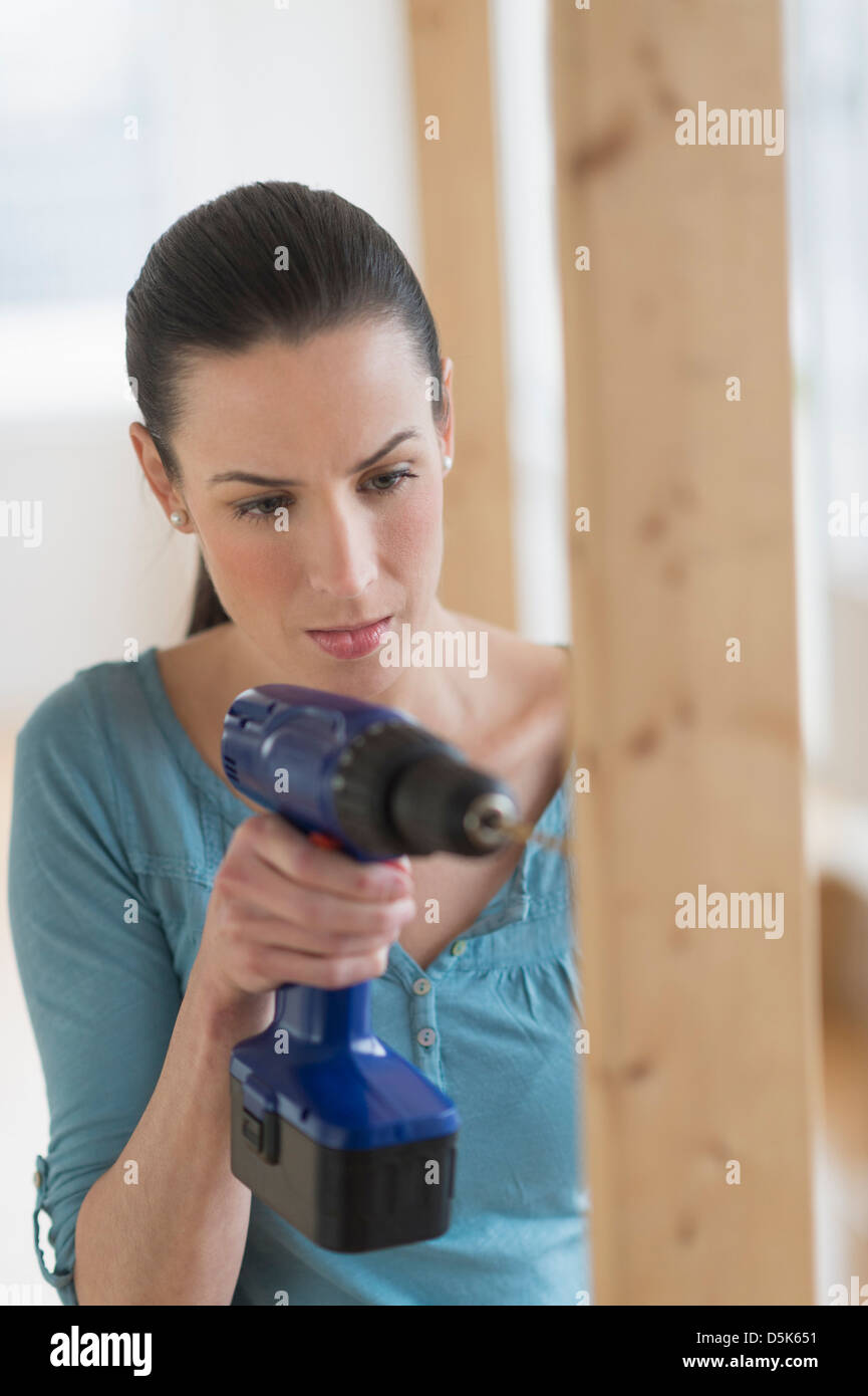 Young diy woman drilling hi-res stock photography and images - Alamy
