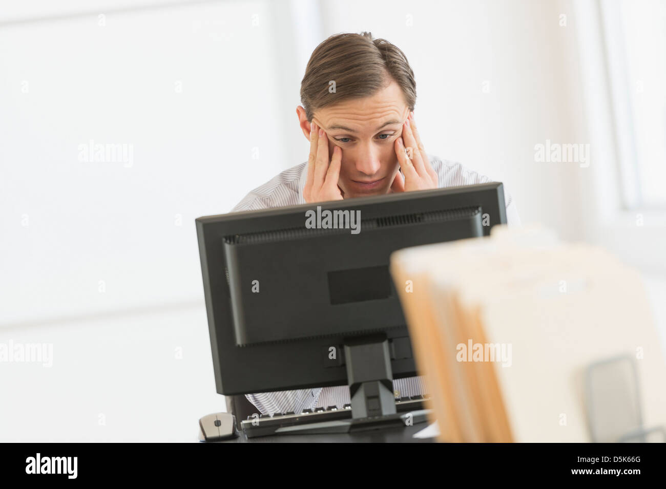 Office worker using computer Stock Photo - Alamy