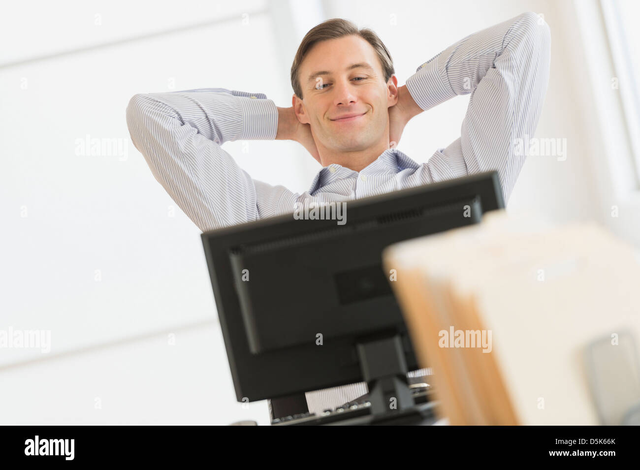 Office worker using computer Stock Photo - Alamy