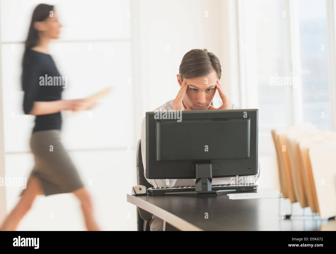 Office worker using computer Stock Photo - Alamy