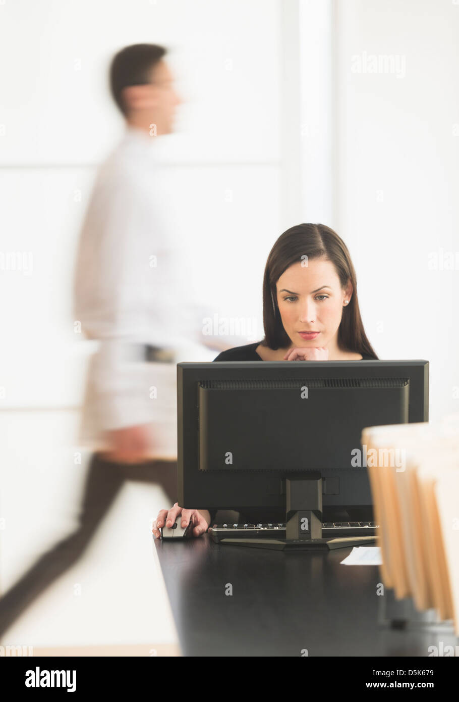 Office worker using computer Stock Photo - Alamy