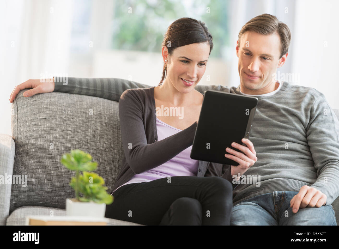 Home sofa couple holding hi-res stock photography and images - Alamy