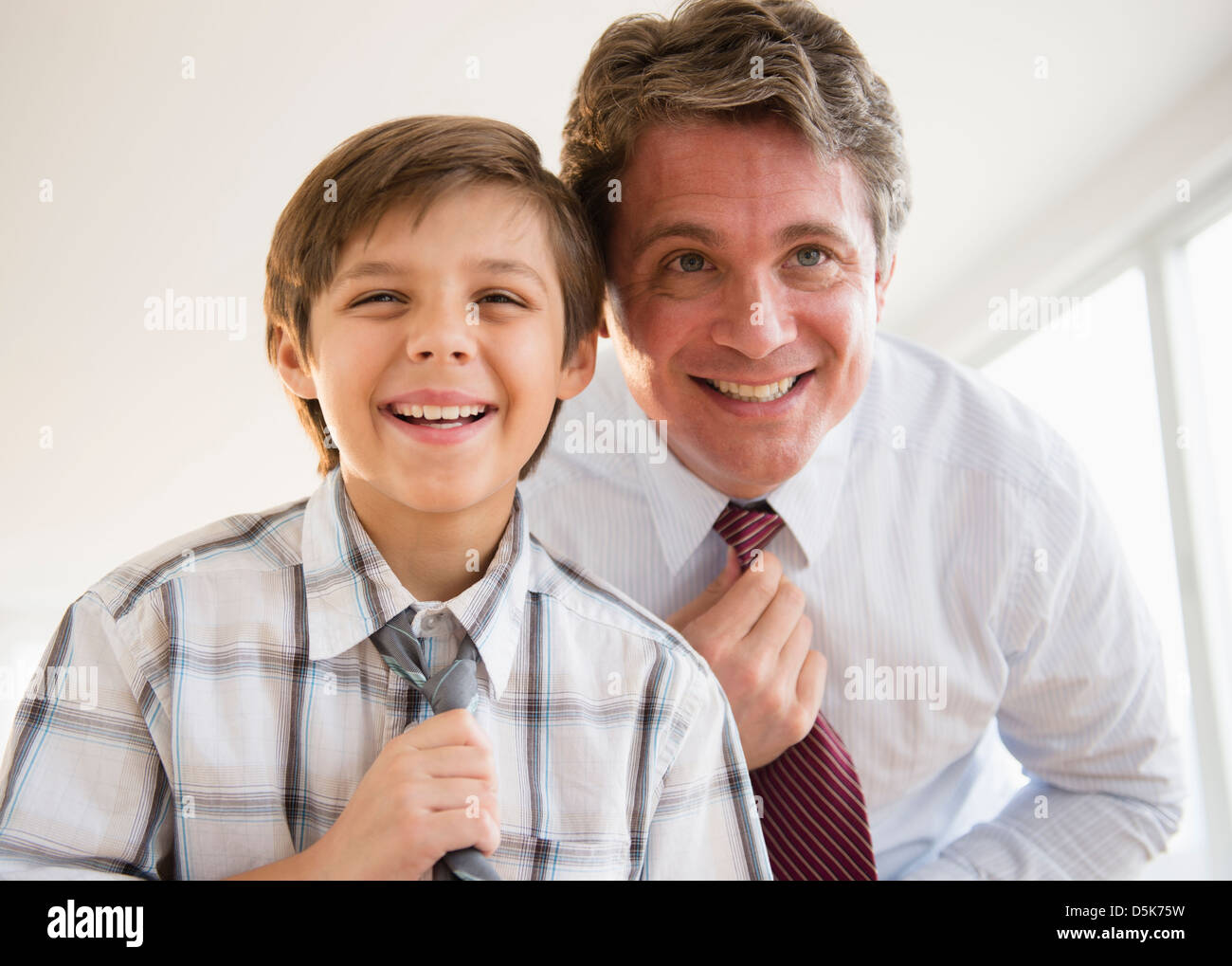 Father and son (8-9) adjusting ties Stock Photo - Alamy