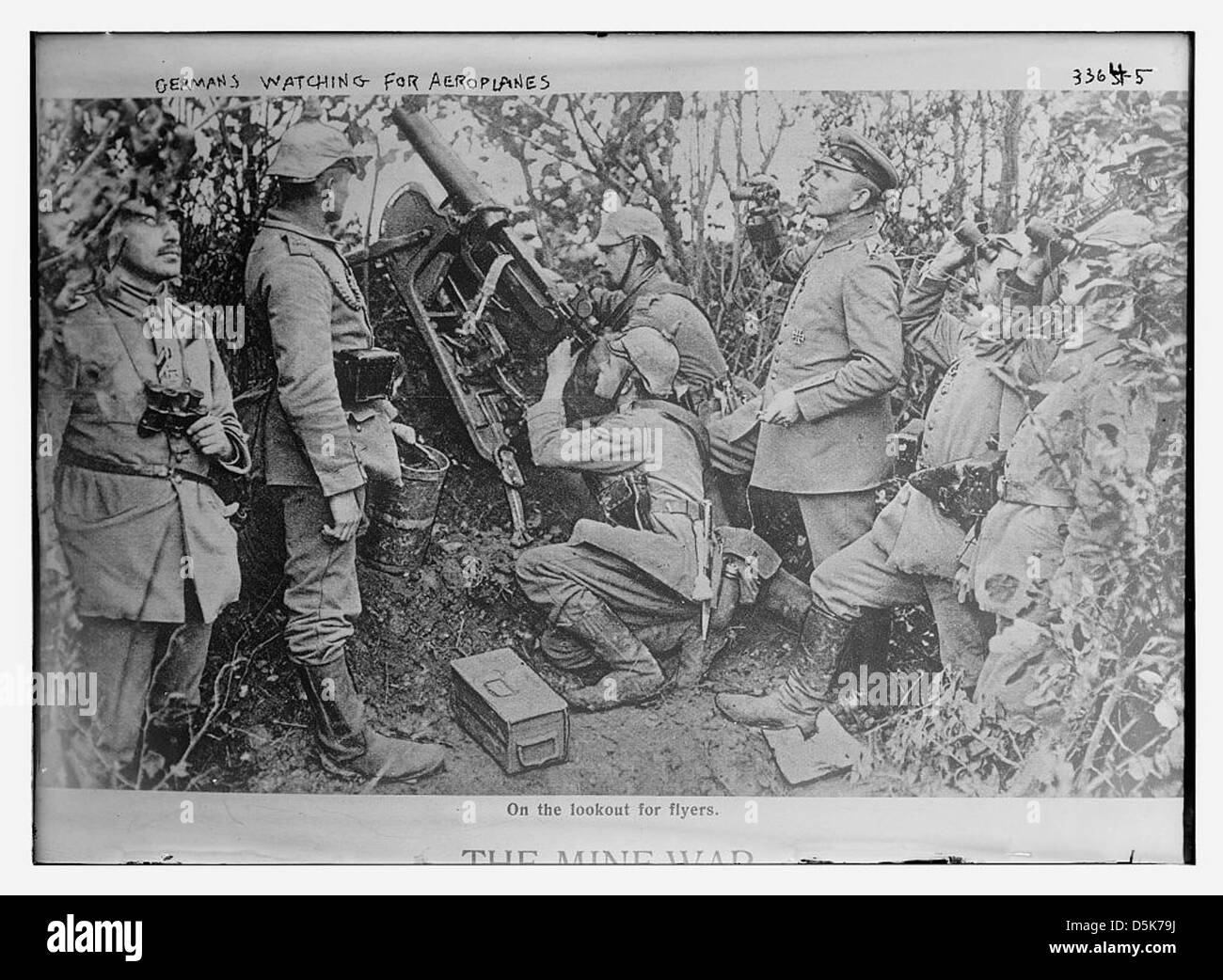 German soldiers, equipped with binoculars and anti-aircraft guns, are ...