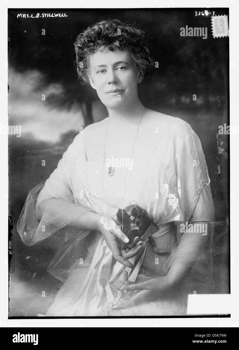 A portrait of Mrs. L.B. Stillwell, with her family members Lewis B ...