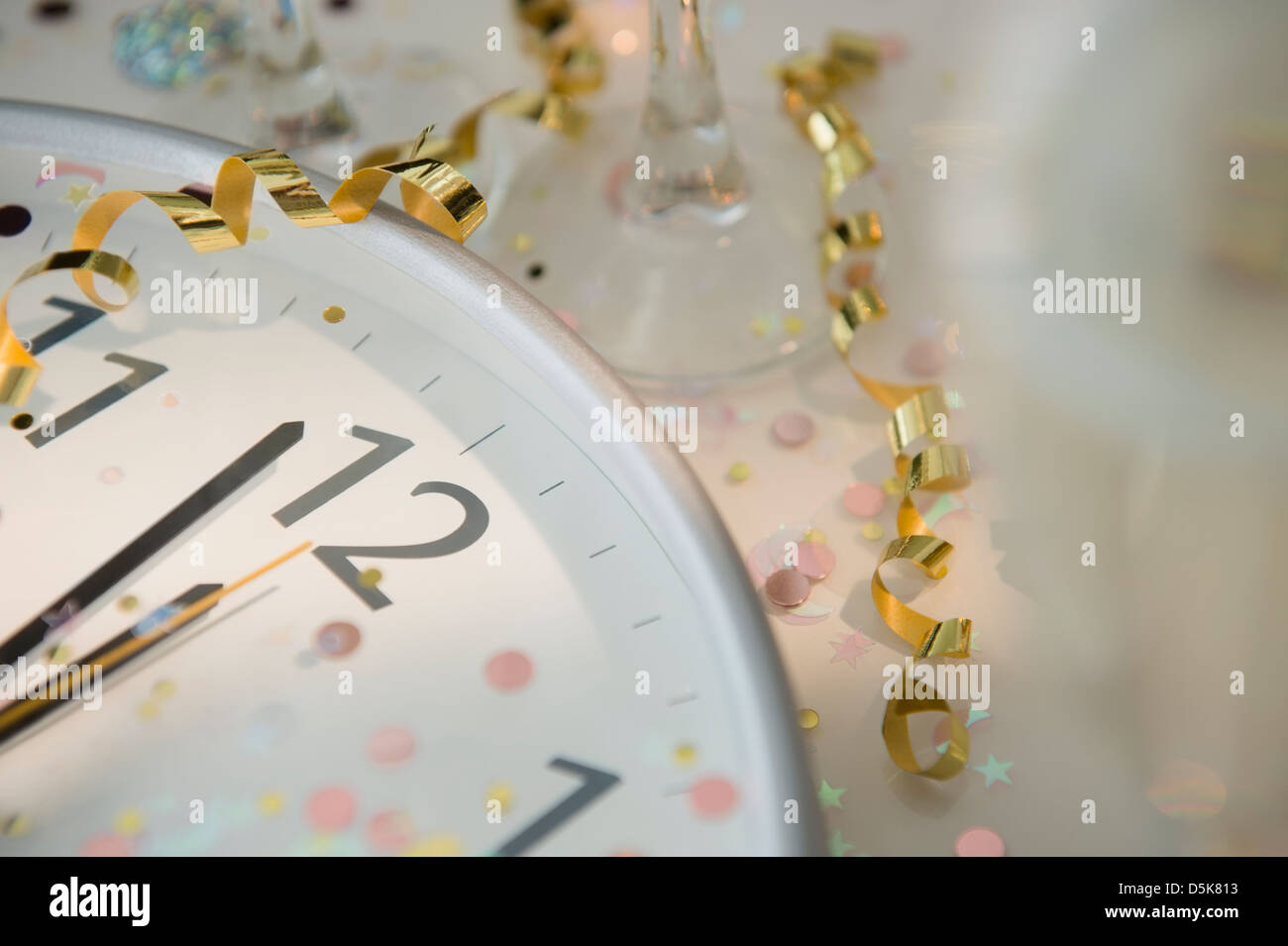 12 o'clock on clock decorated with confetti and streamer Stock Photo ...