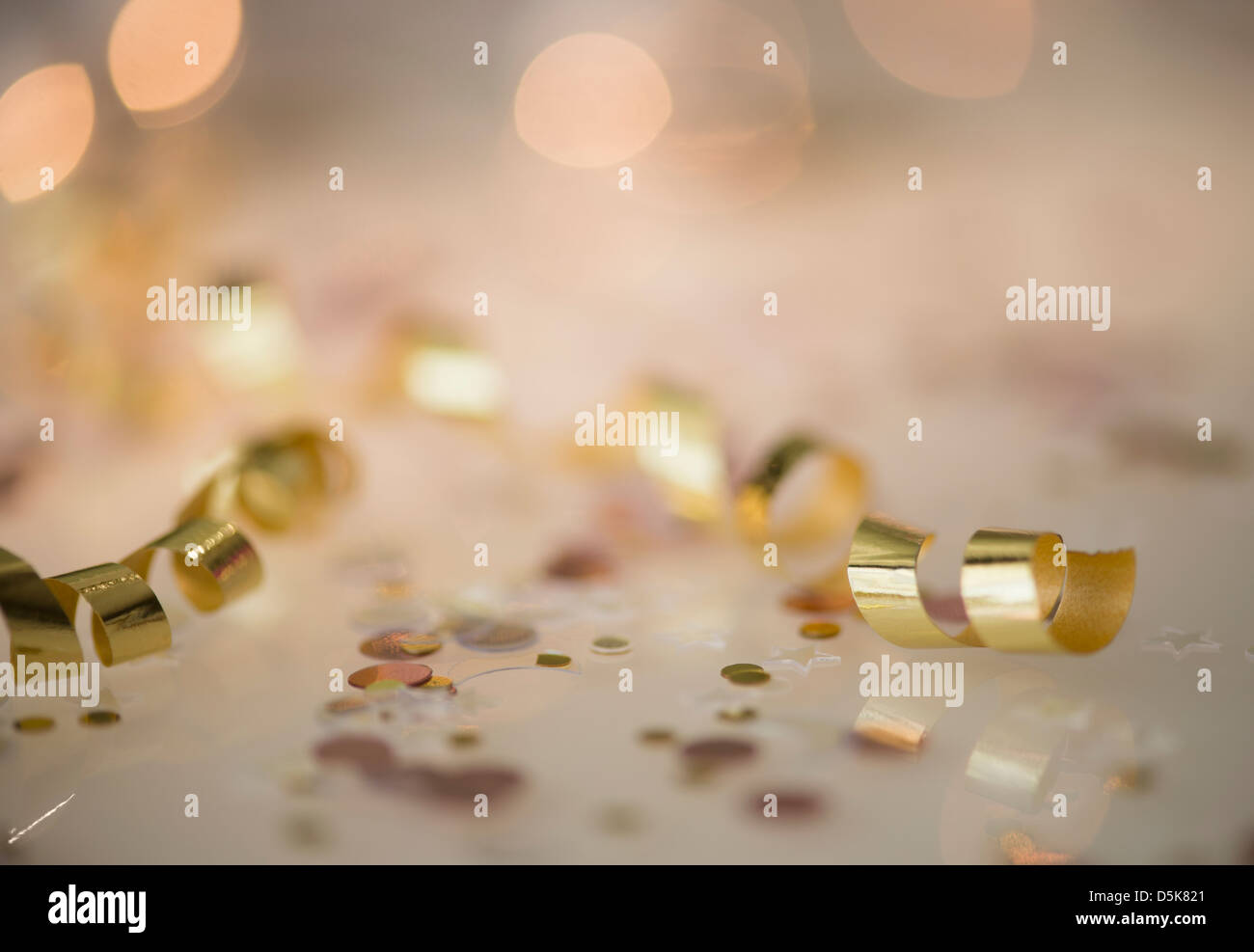 Close-up of gold streamer and confetti Stock Photo - Alamy