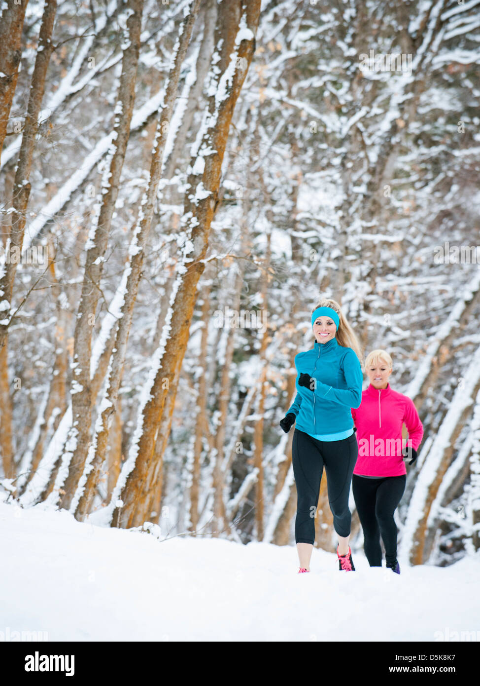 USA, Utah, Salt Lake City, Two women jogging in winter forest Stock ...