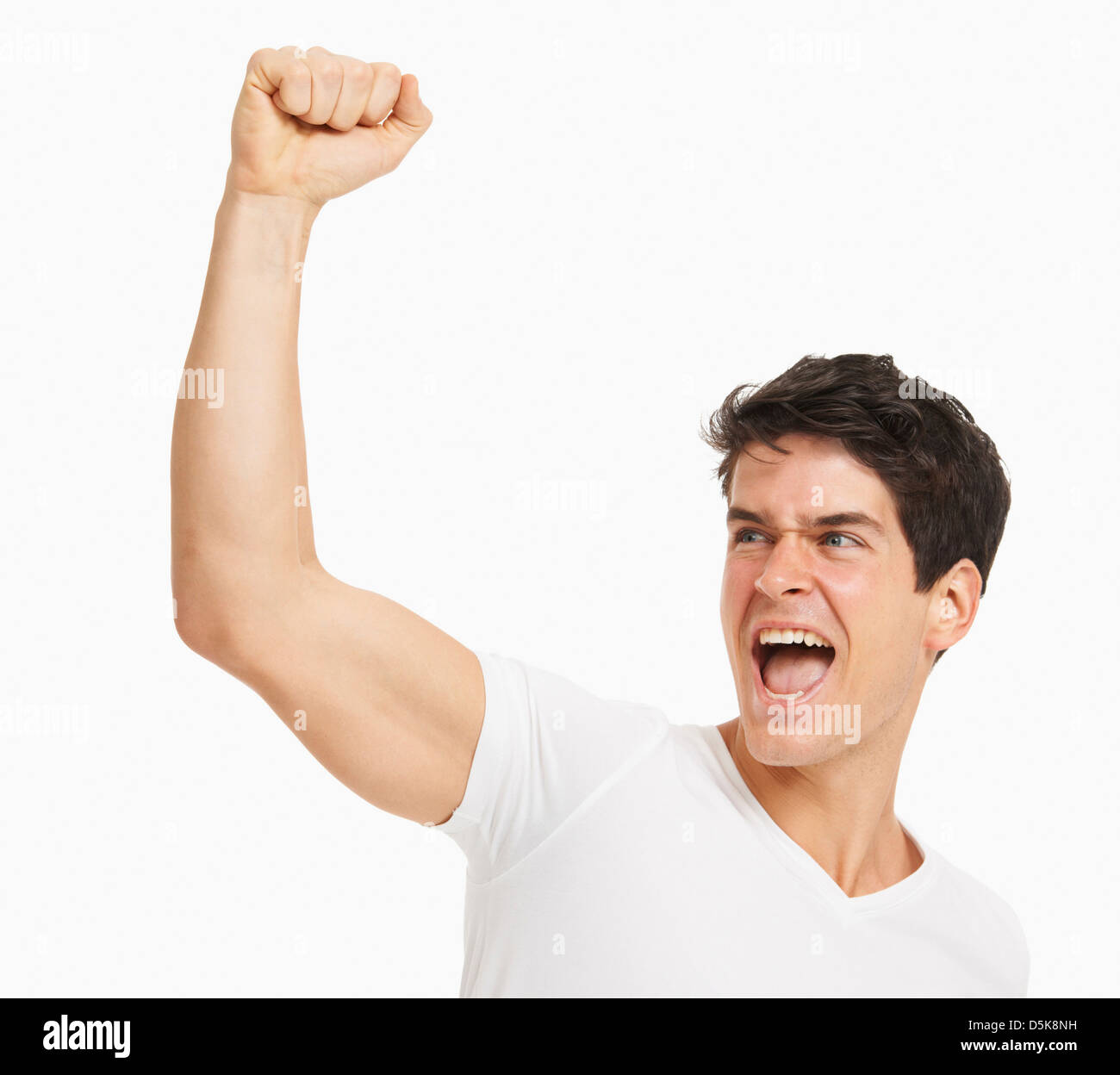 Studio portrait of handsome man cheering Stock Photo - Alamy