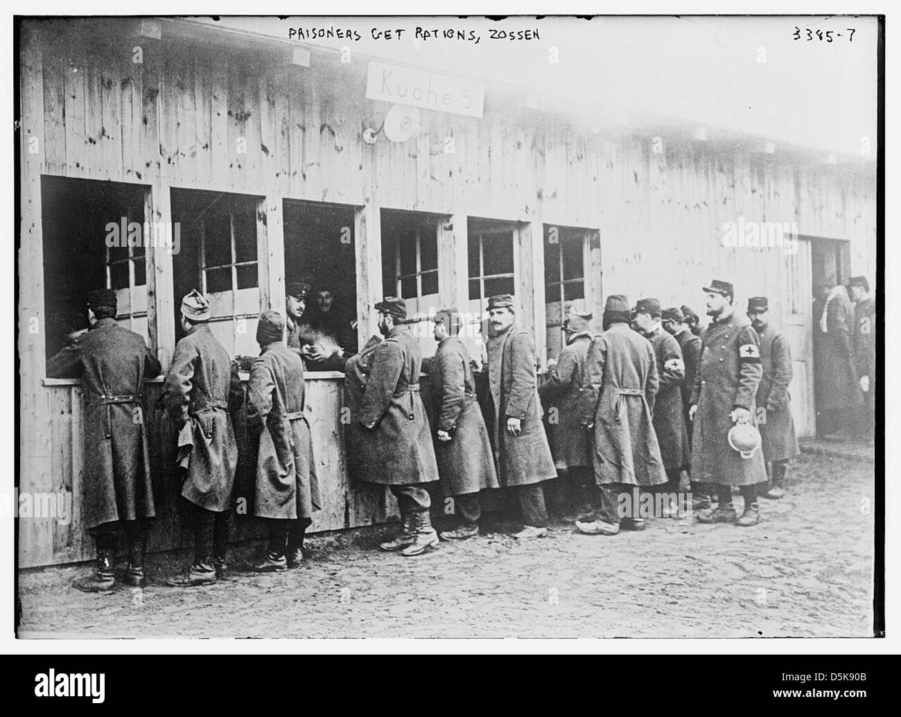 Prisoners of war are shown receiving rations at the Zossen prison camp ...