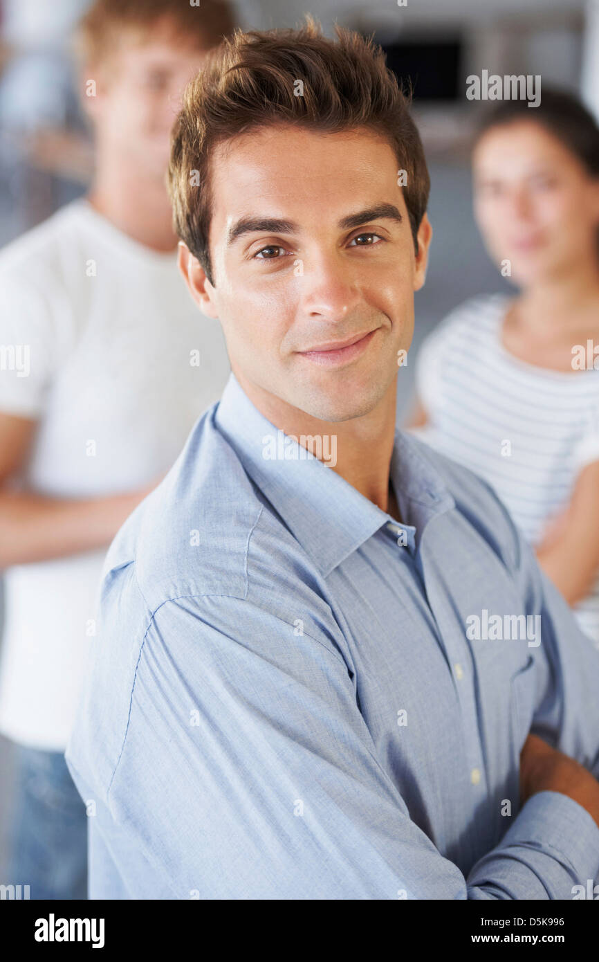 Portrait of man with coworkers in background Stock Photo - Alamy