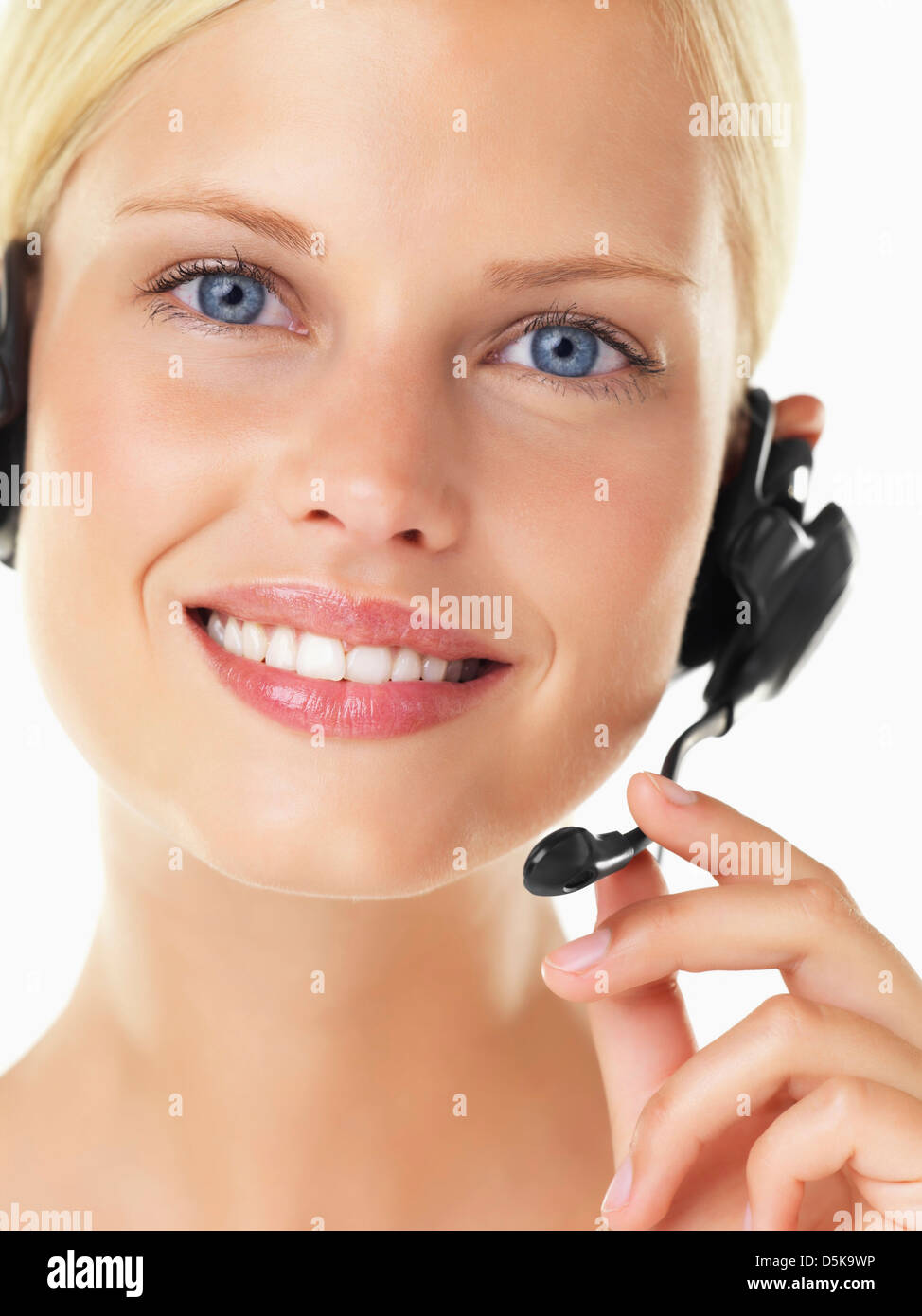 Studio portrait of young woman wearing headset Stock Photo - Alamy