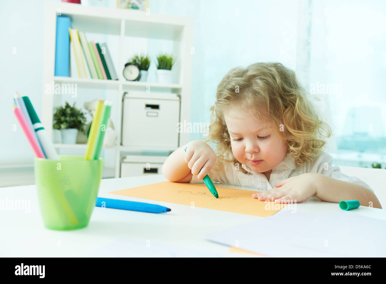 Diligent preschool child drawing at home Stock Photo - Alamy