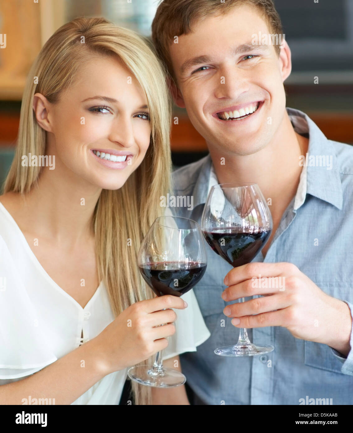 Couple toasting with wine Stock Photo - Alamy
