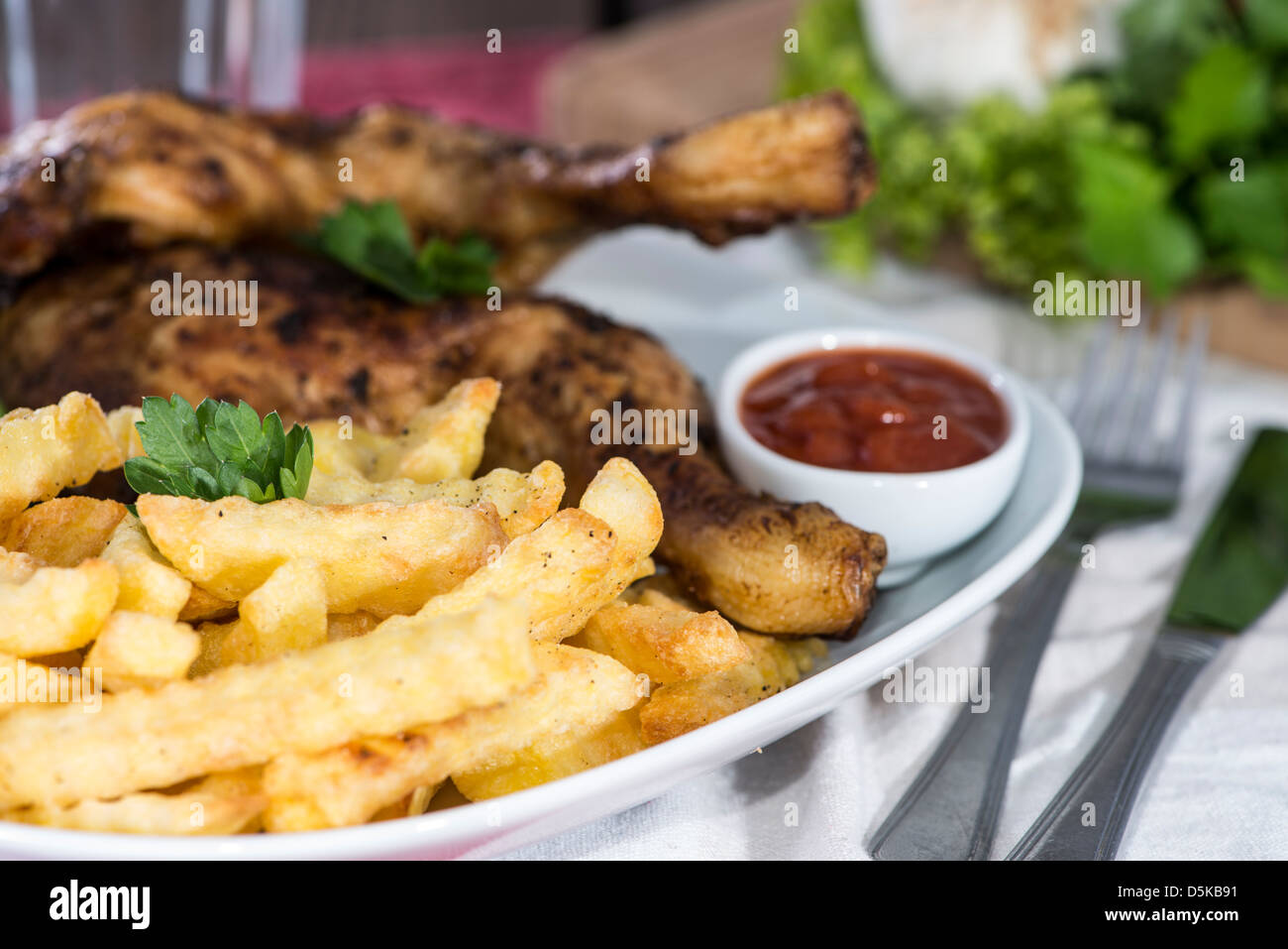 Portion of Chicken Legs with sauce and chips Stock Photo - Alamy