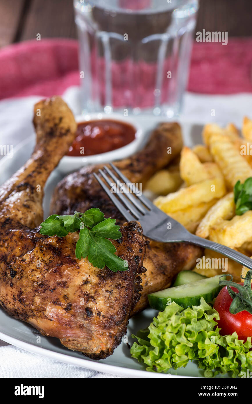 Portion of grilled Chicken Legs with Chips Stock Photo - Alamy
