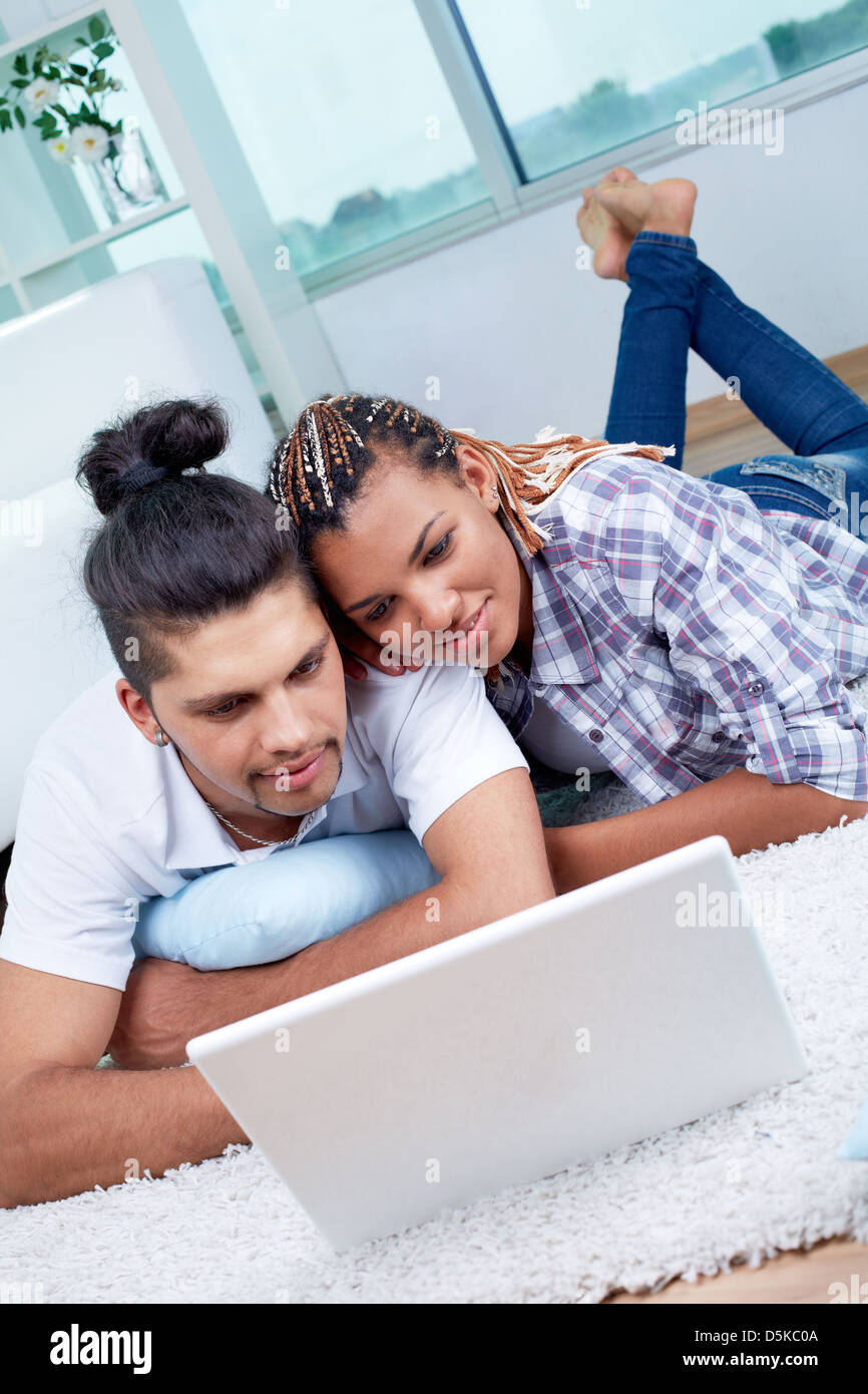 Image of young guy and his girlfriend using laptop at home Stock Photo ...