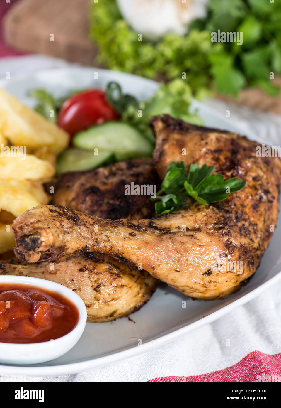 Portion of Chicken Legs with sauce and chips Stock Photo - Alamy