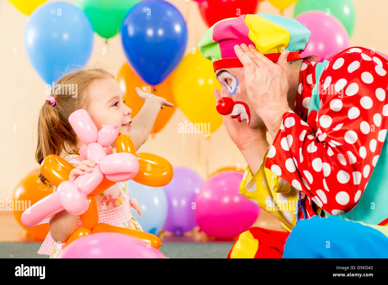 happy child girl and clown playing on birthday party Stock Photo - Alamy