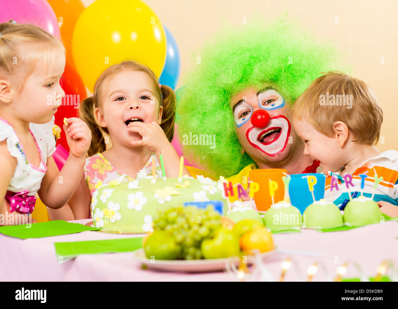 kids celebrating birthday party with clown Stock Photo - Alamy