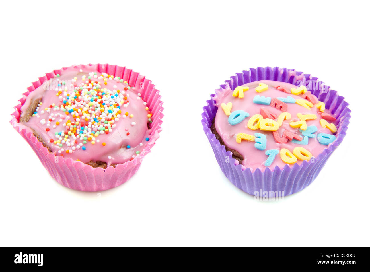 Two fancy colorful decorated cup cakes isolated over white Stock Photo ...