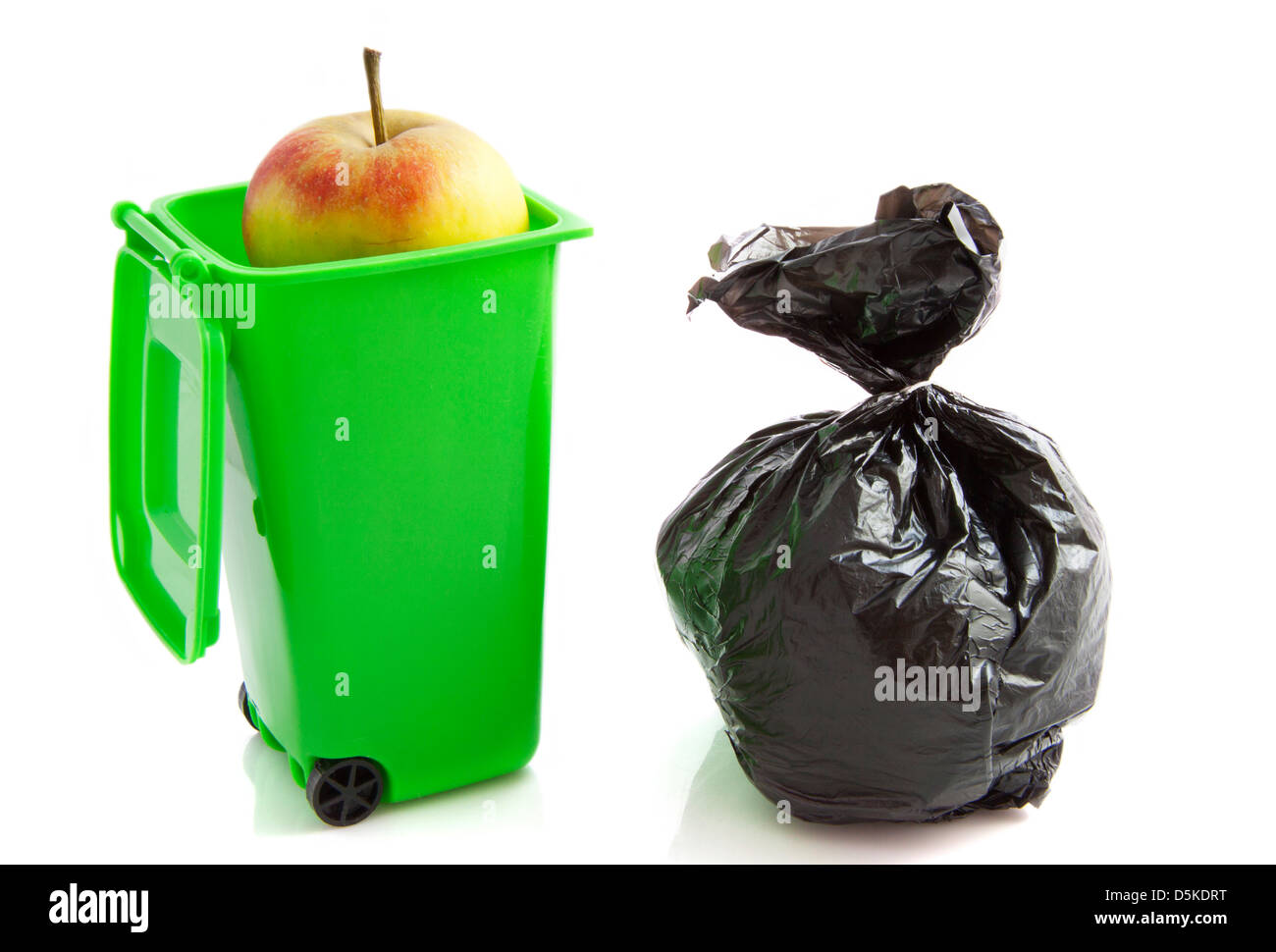 Green garbage bag with apple and plastic bag isolated over white Stock ...