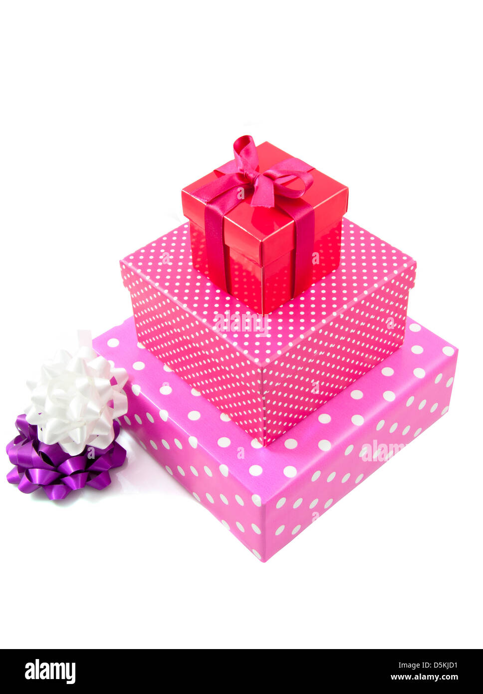 Three colorful presents on a pile isolated over white Stock Photo - Alamy