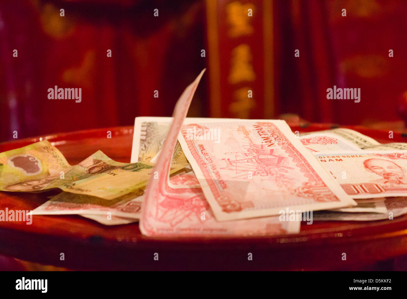 A temple in Hanoi with a donation bowl full of currency notes Stock ...
