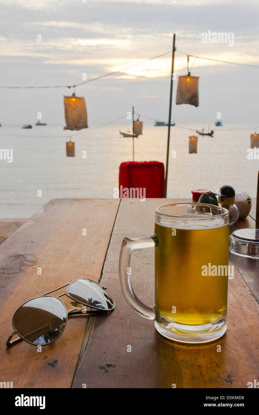 Beach front bar table with drinks and sunglasses on Ko Tao island on ...