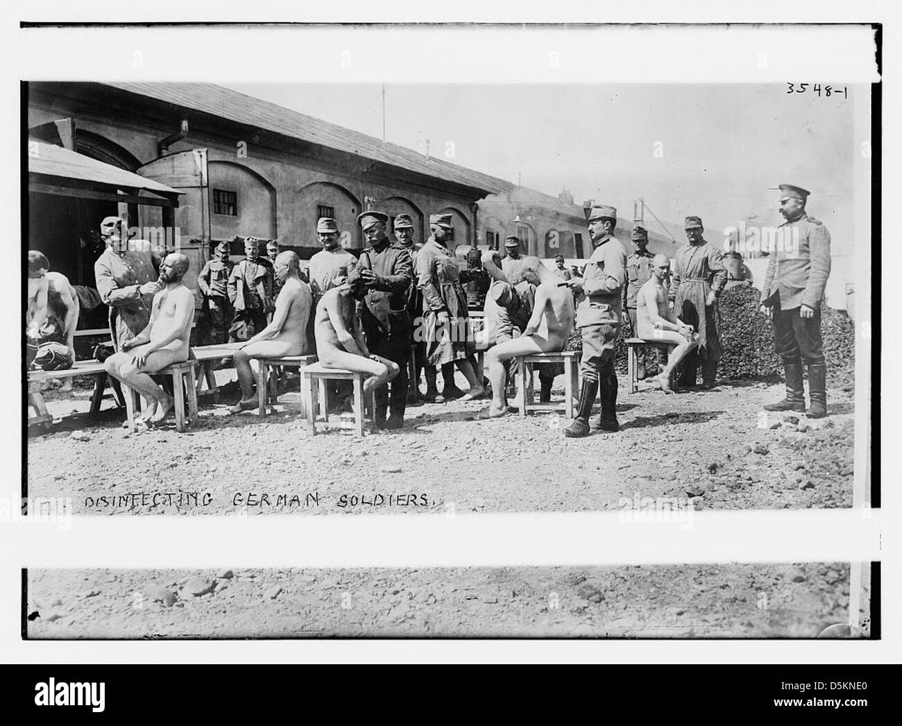 This photograph depicts German soldiers being disinfected during World ...