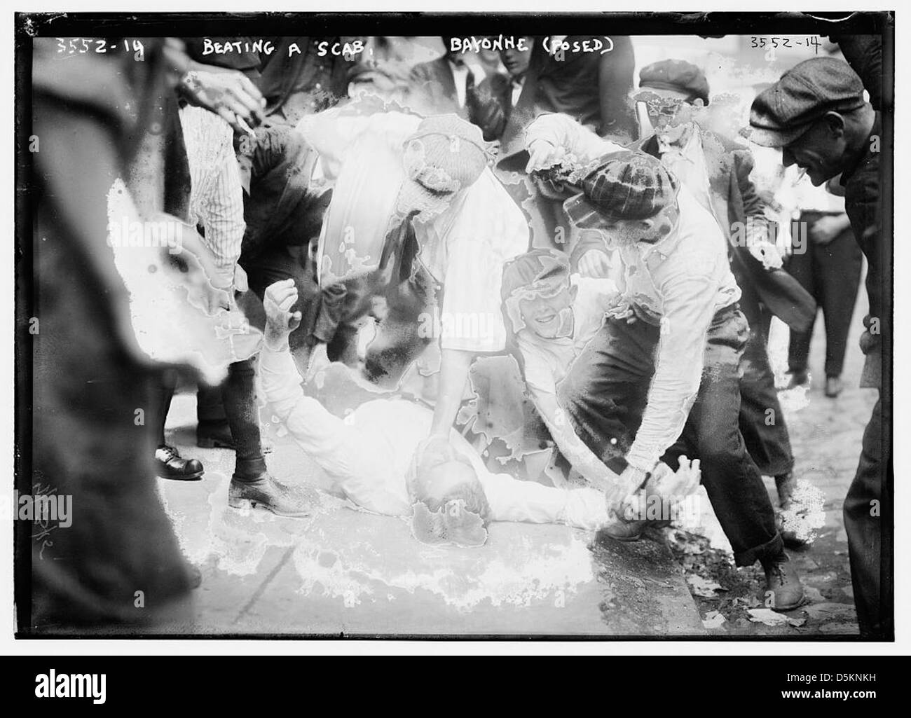 A posed photograph depicting a worker beating a scab during a refinery ...