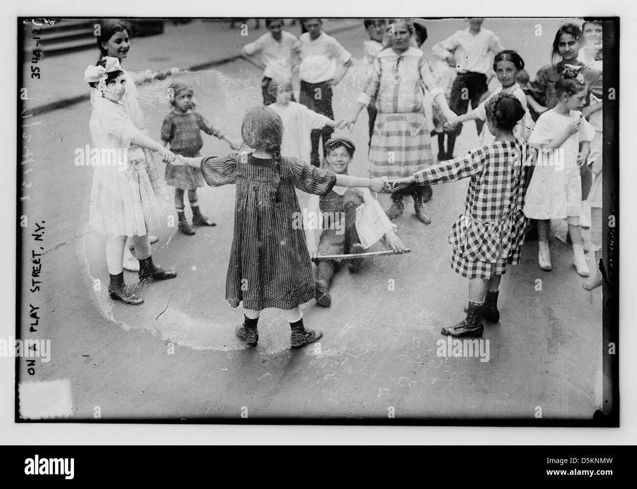 This photograph captures a street scene in New York, showcasing a play ...