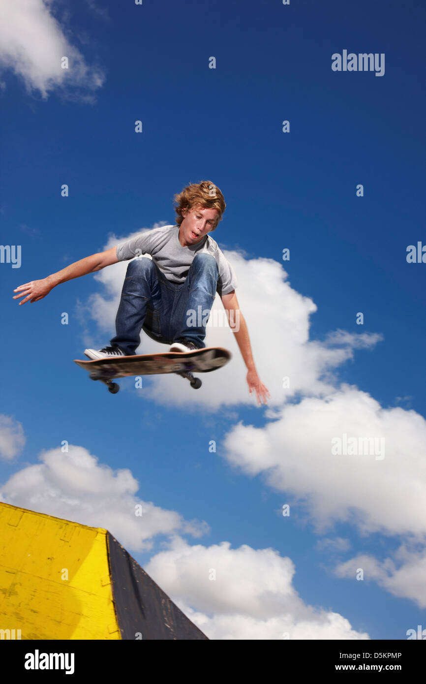 Young man on skateboard jumping Stock Photo - Alamy